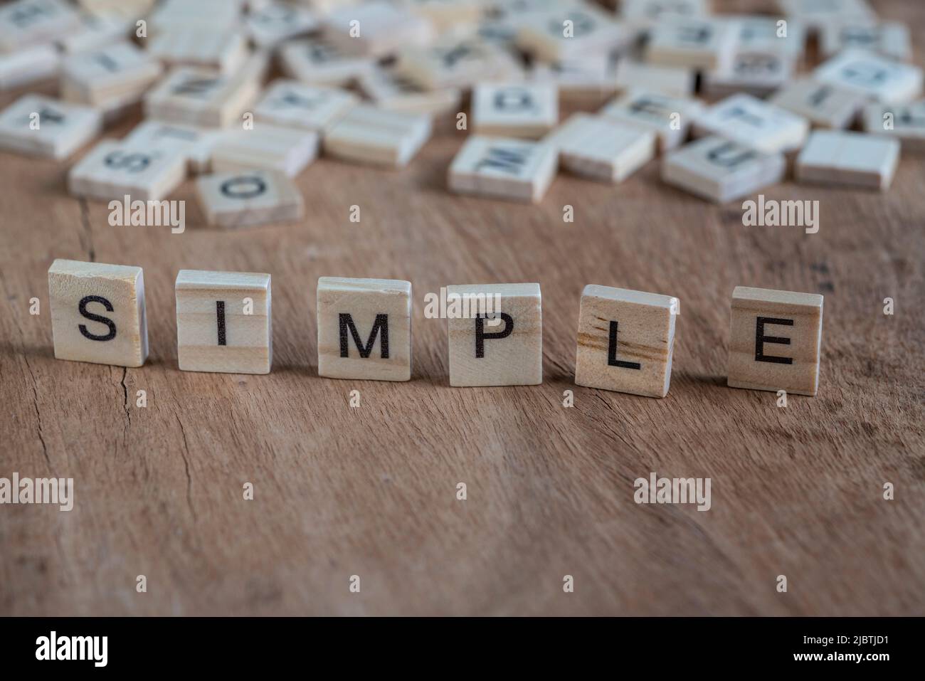 the word simple written with cube letters on wooden background Stock ...