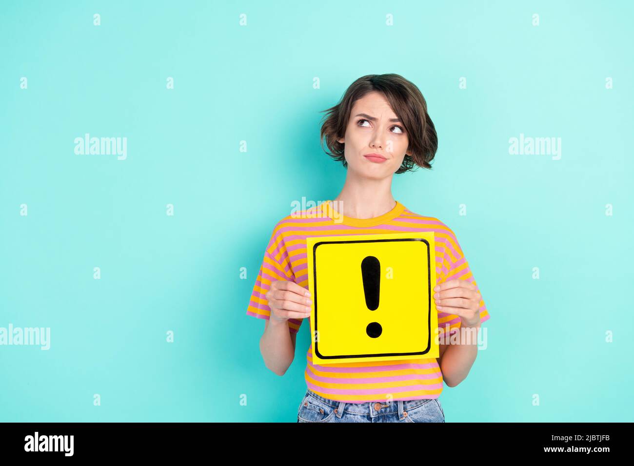 Photo of cute doubtful lady wear orange t-shirt holding exclamation ...