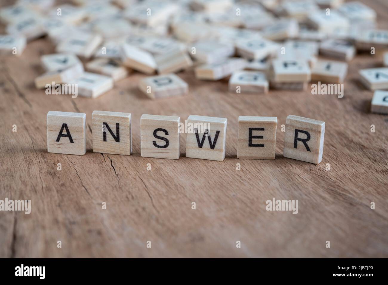 the word answer written with cube letters on wooden background Stock ...