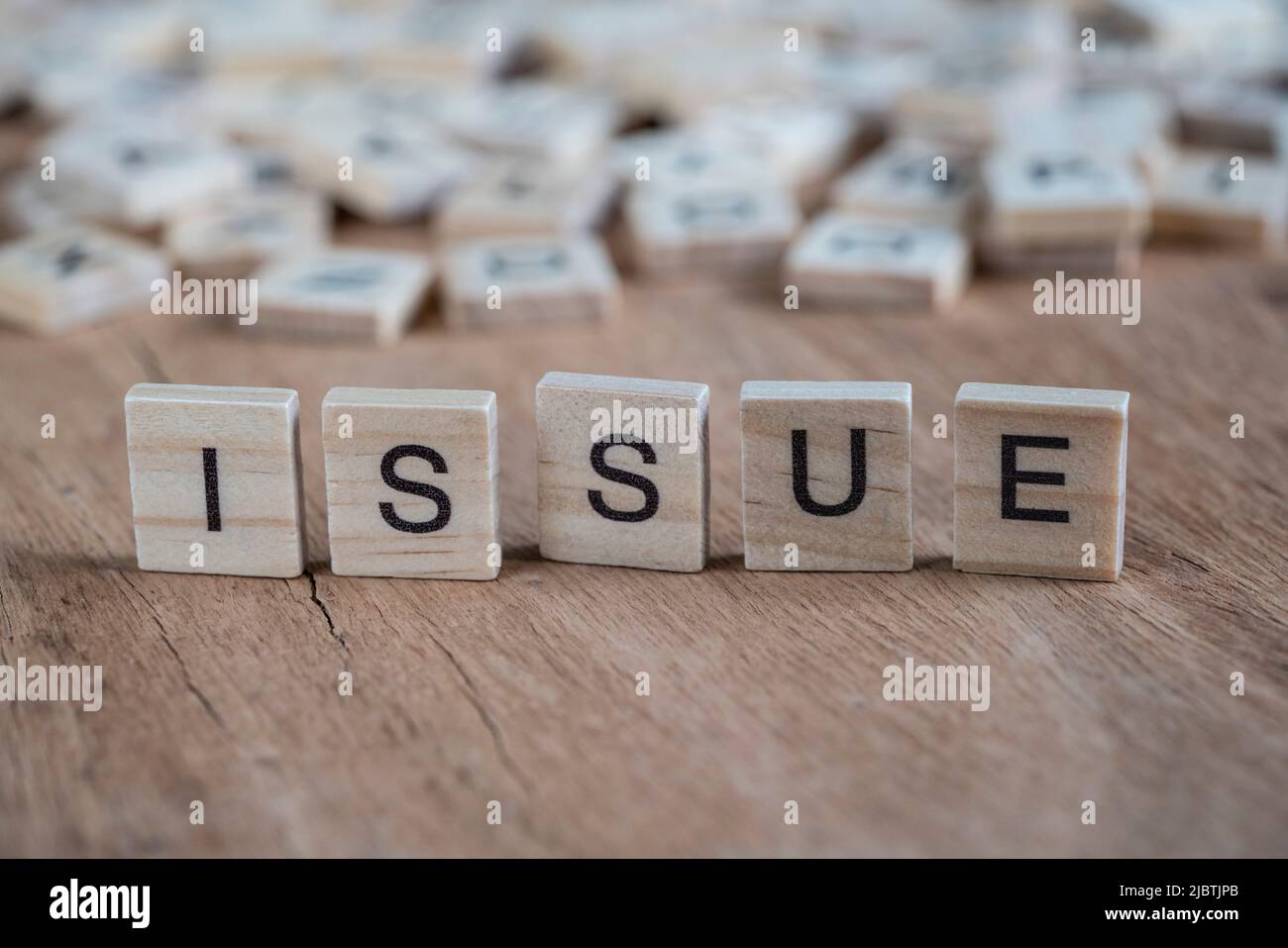 the word issue written with cube letters on wooden background Stock ...