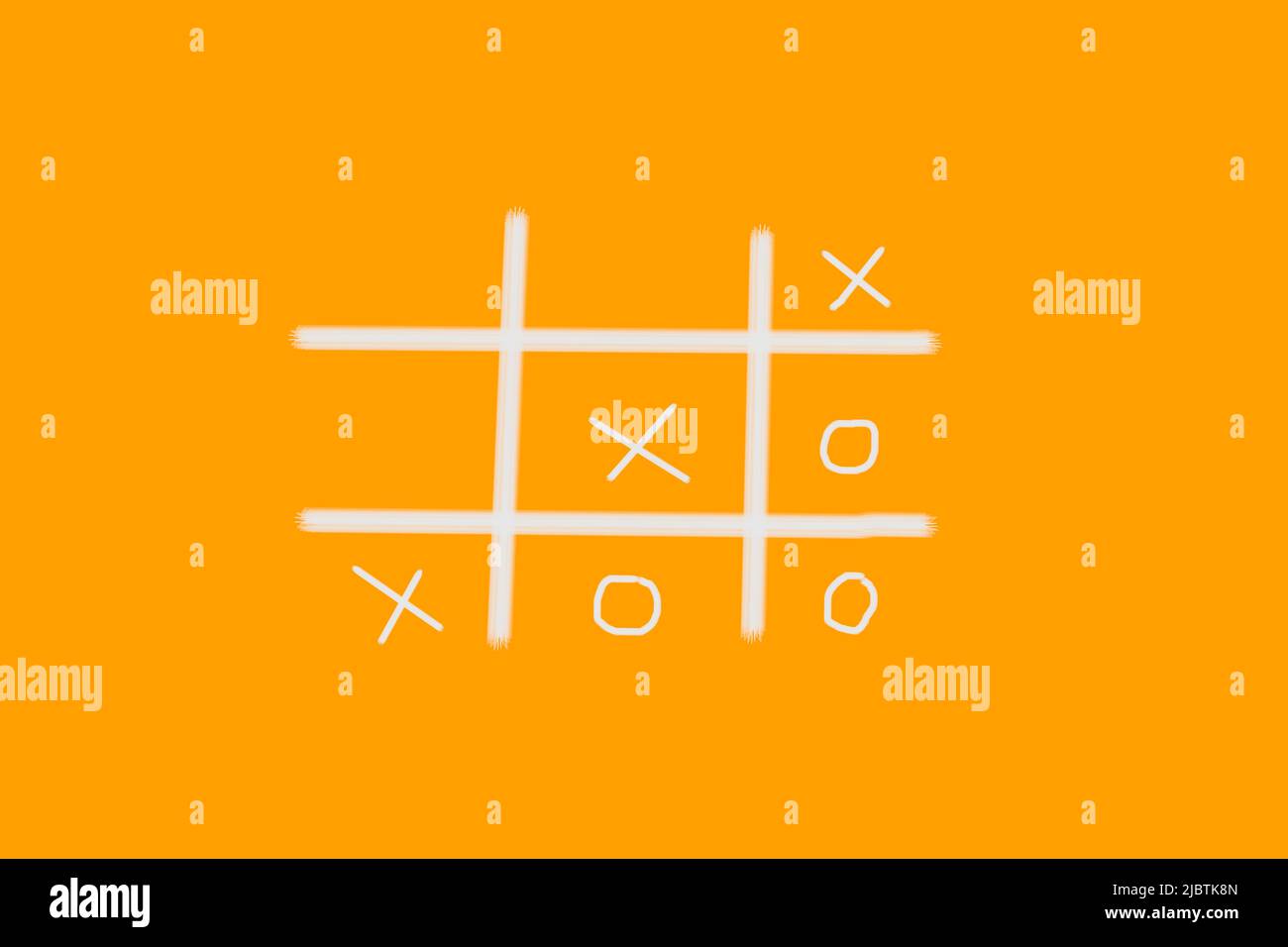 Tic tac toe game on an orange background Stock Photo - Alamy