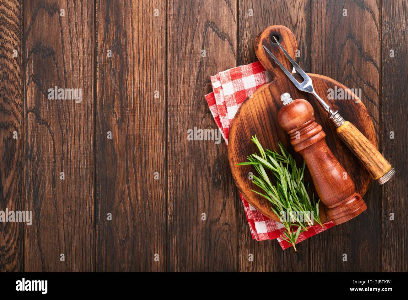 Food background. Grill fork, pepper shaker and rosemary branch, red ...