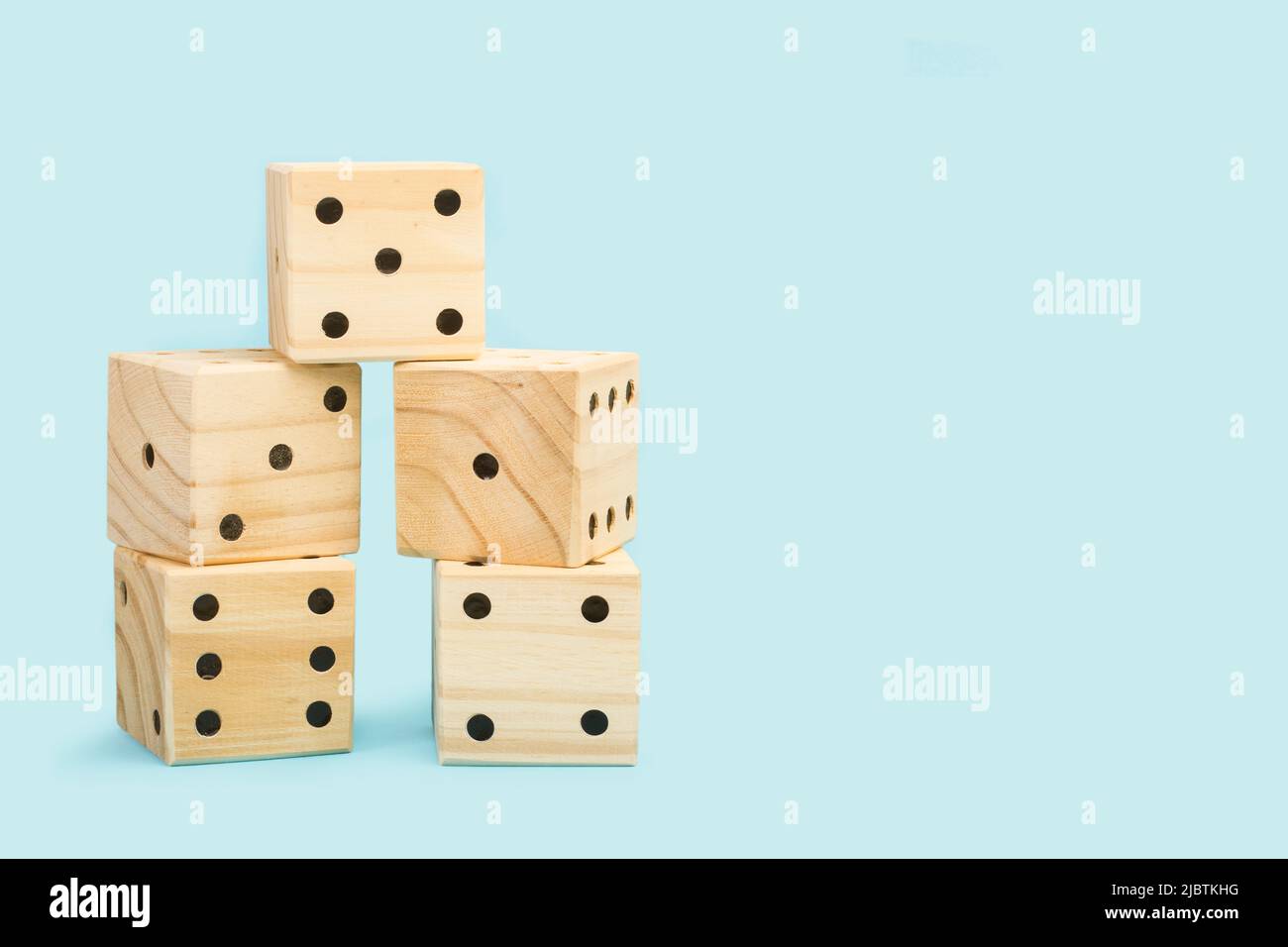 A heap of wooden dices on a light blue background with copy space Stock ...