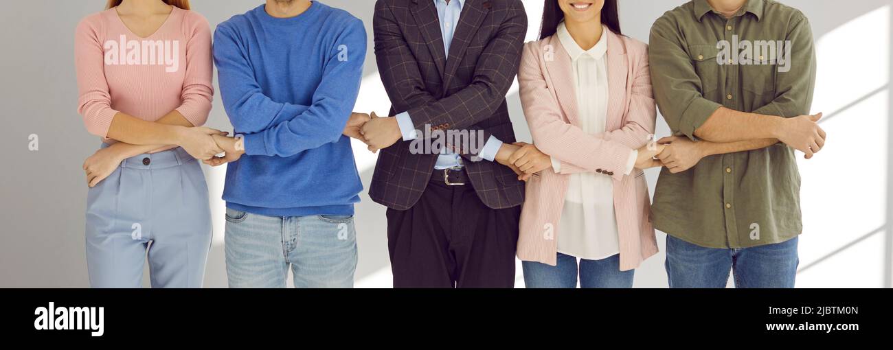 Team of happy young business people who work together standing in row ...