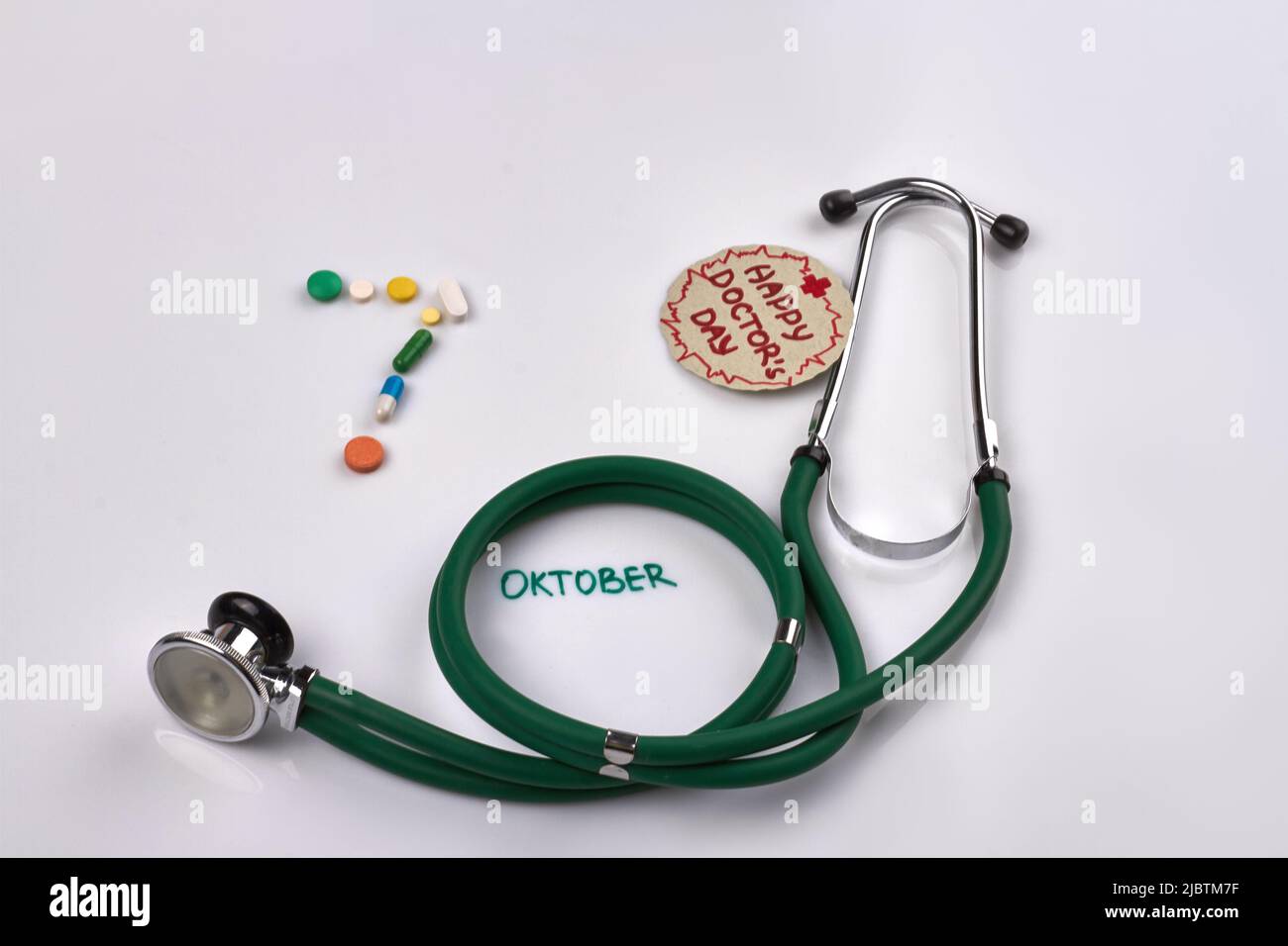 Top view stethoscope with colorful tables and pills on white background ...