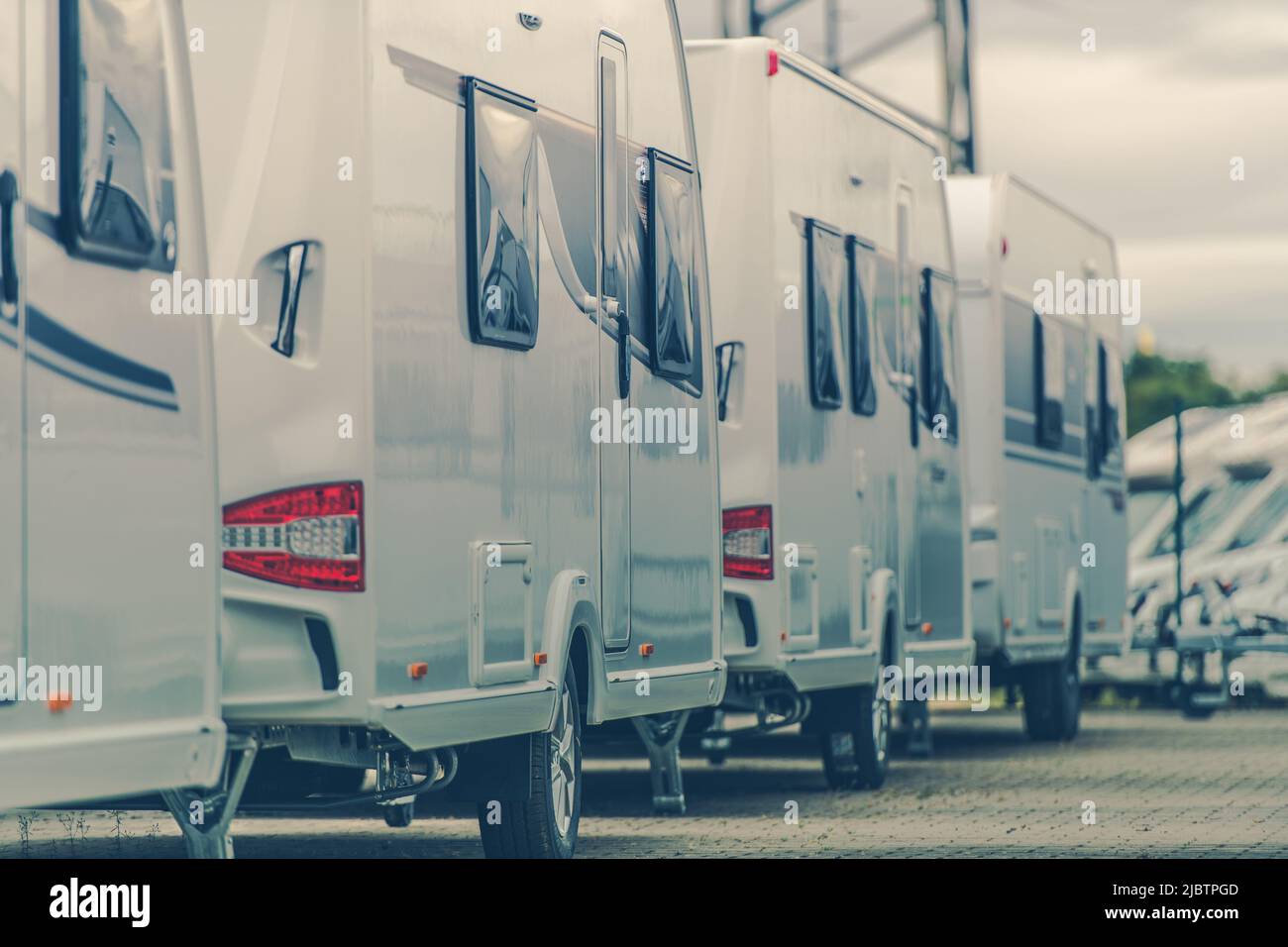 RV Dealership. Line of Brand New White Trailers Parked in the Dealer's ...