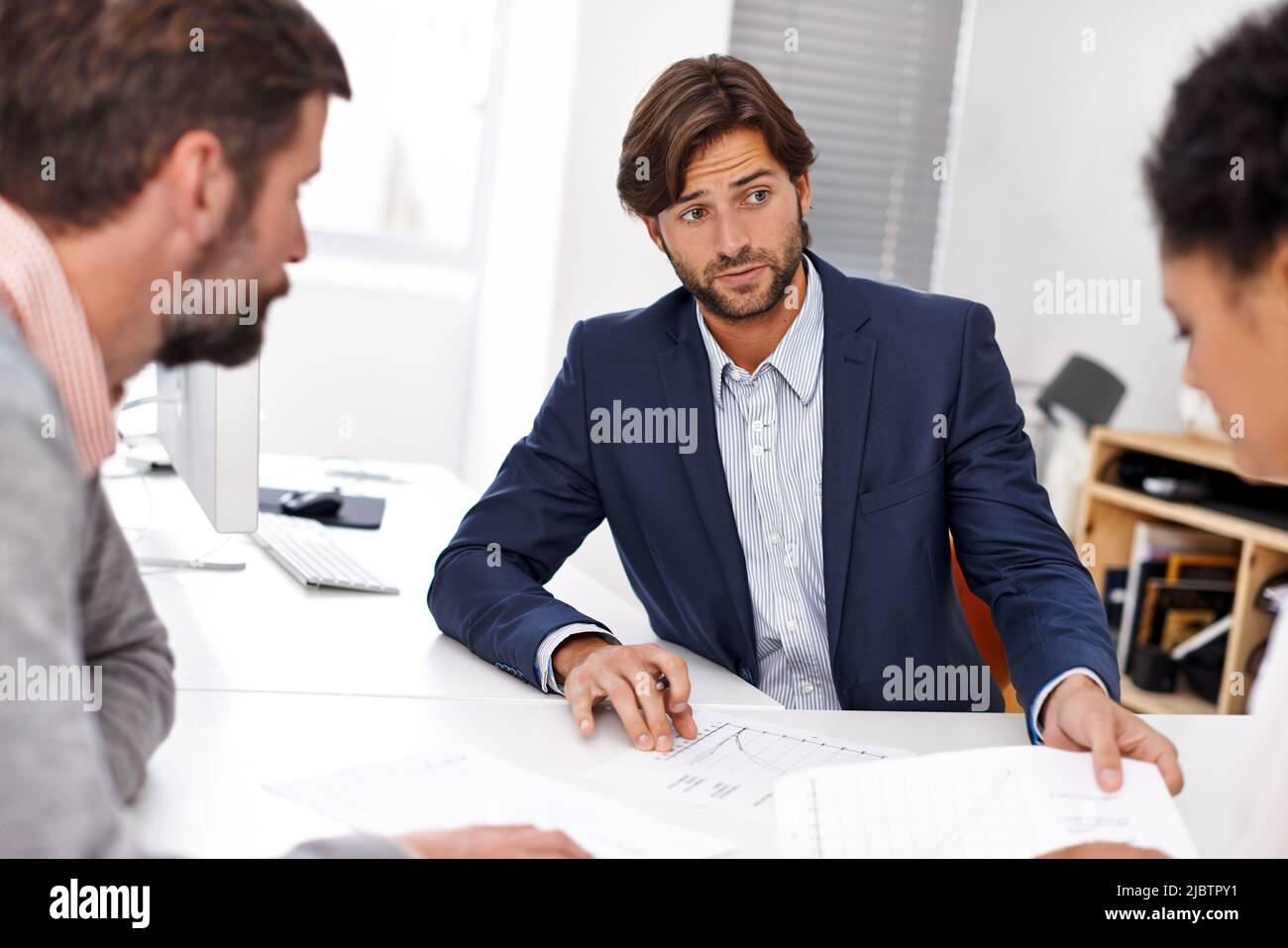 Leading their company to success. Portrait of a group of young office ...