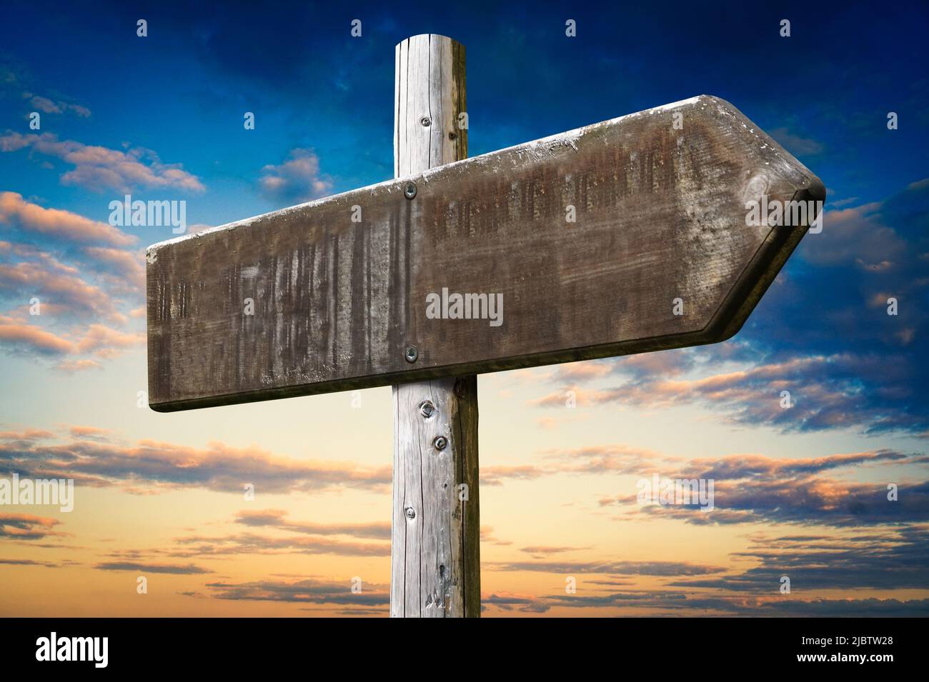 Wooden signpost with an arrow Stock Photo - Alamy
