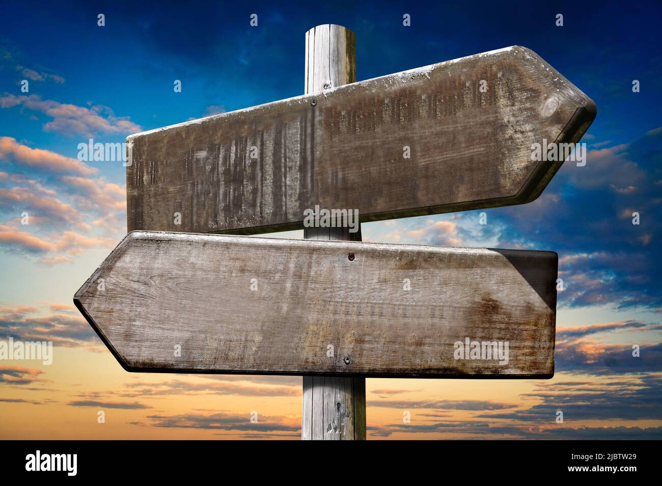 Wooden crossroad sign with two arrows Stock Photo - Alamy