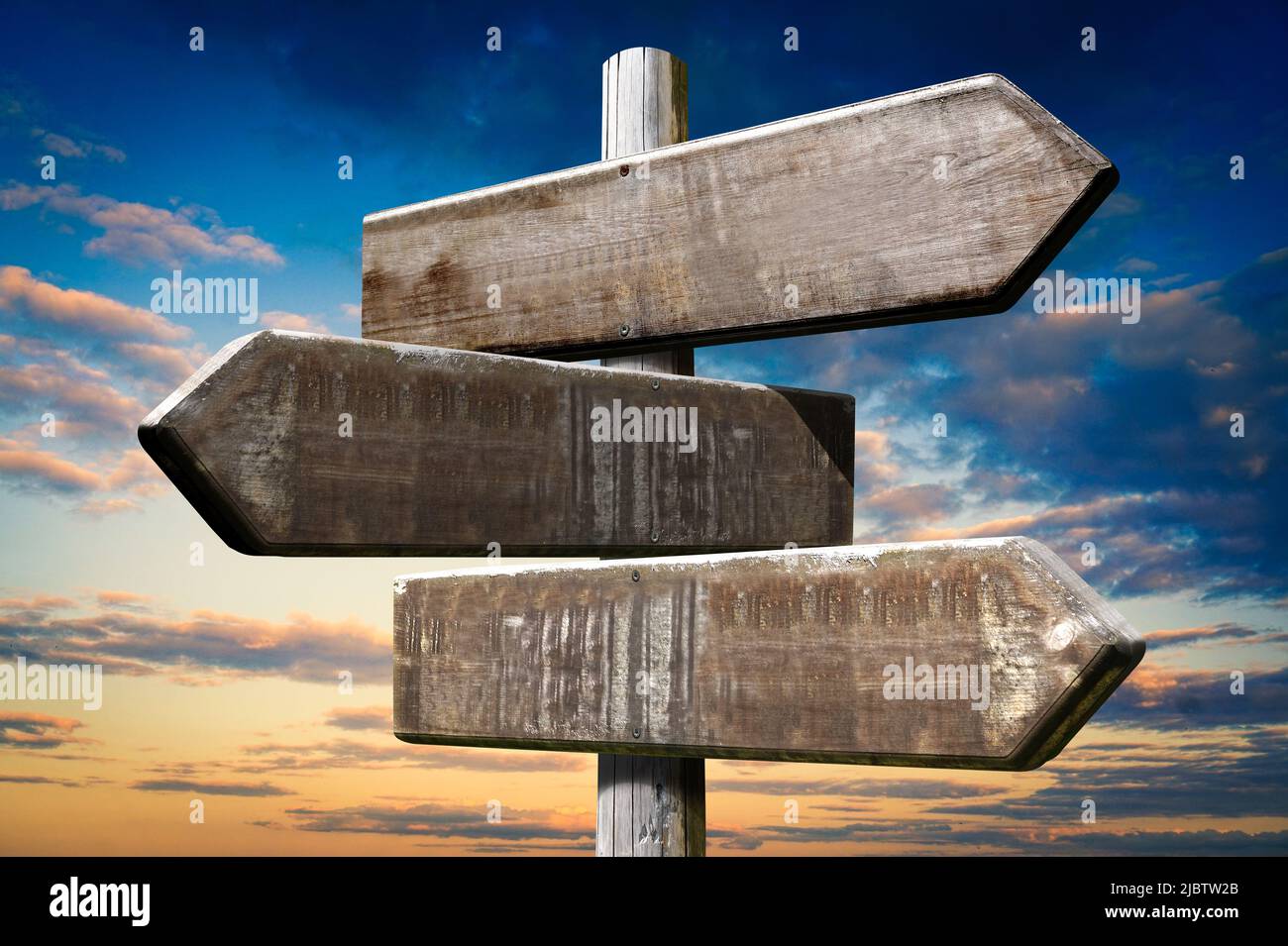 Wooden crossroad sign with three arrows Stock Photo - Alamy