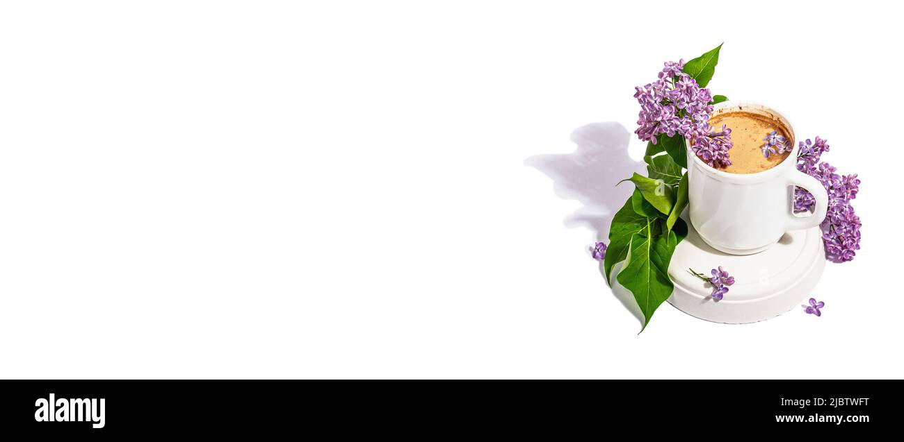 Cup of coffee and lilac flowers bouquet isolated on a white background ...