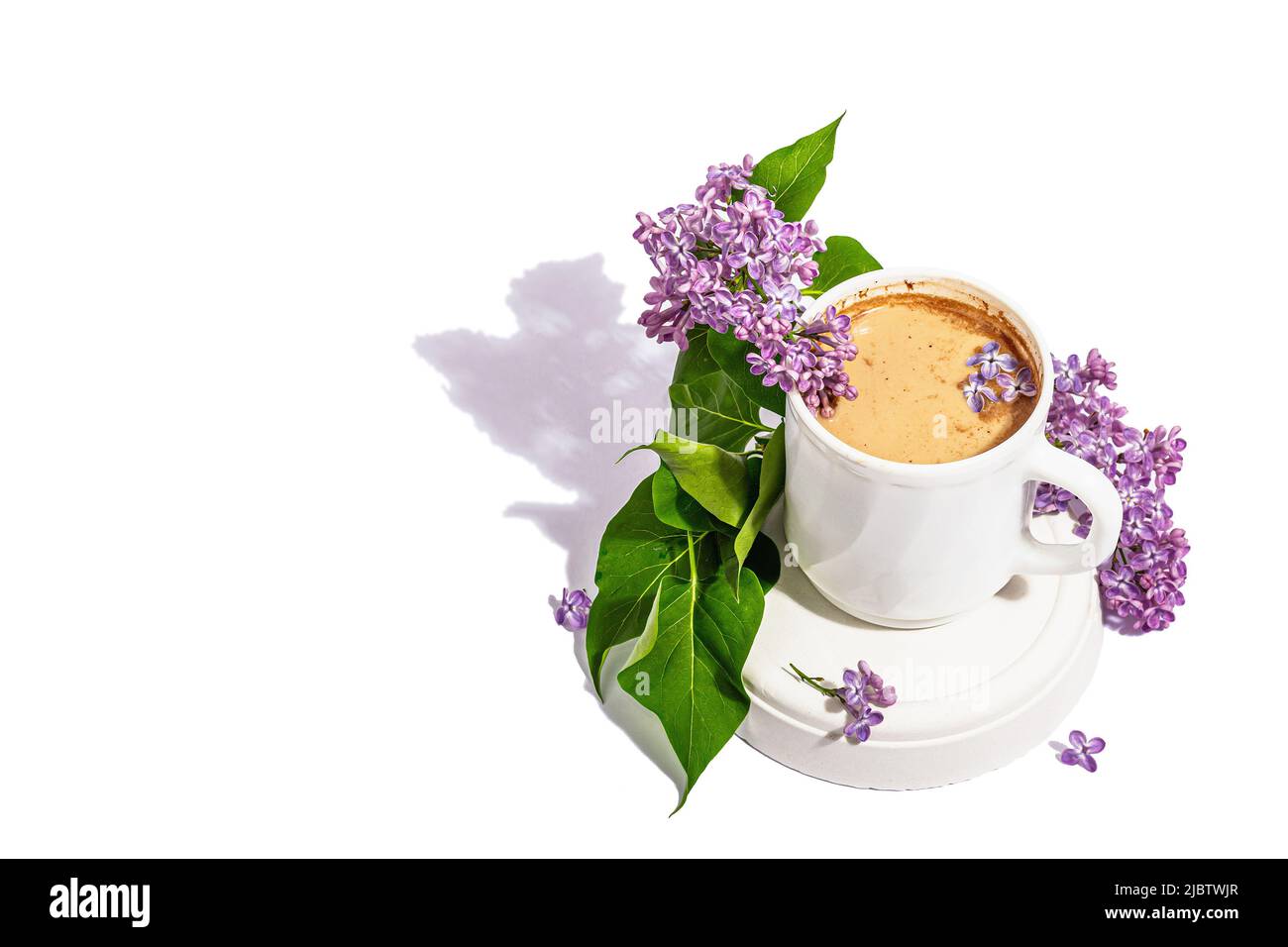 Cup of coffee and lilac flowers bouquet isolated on a white background ...