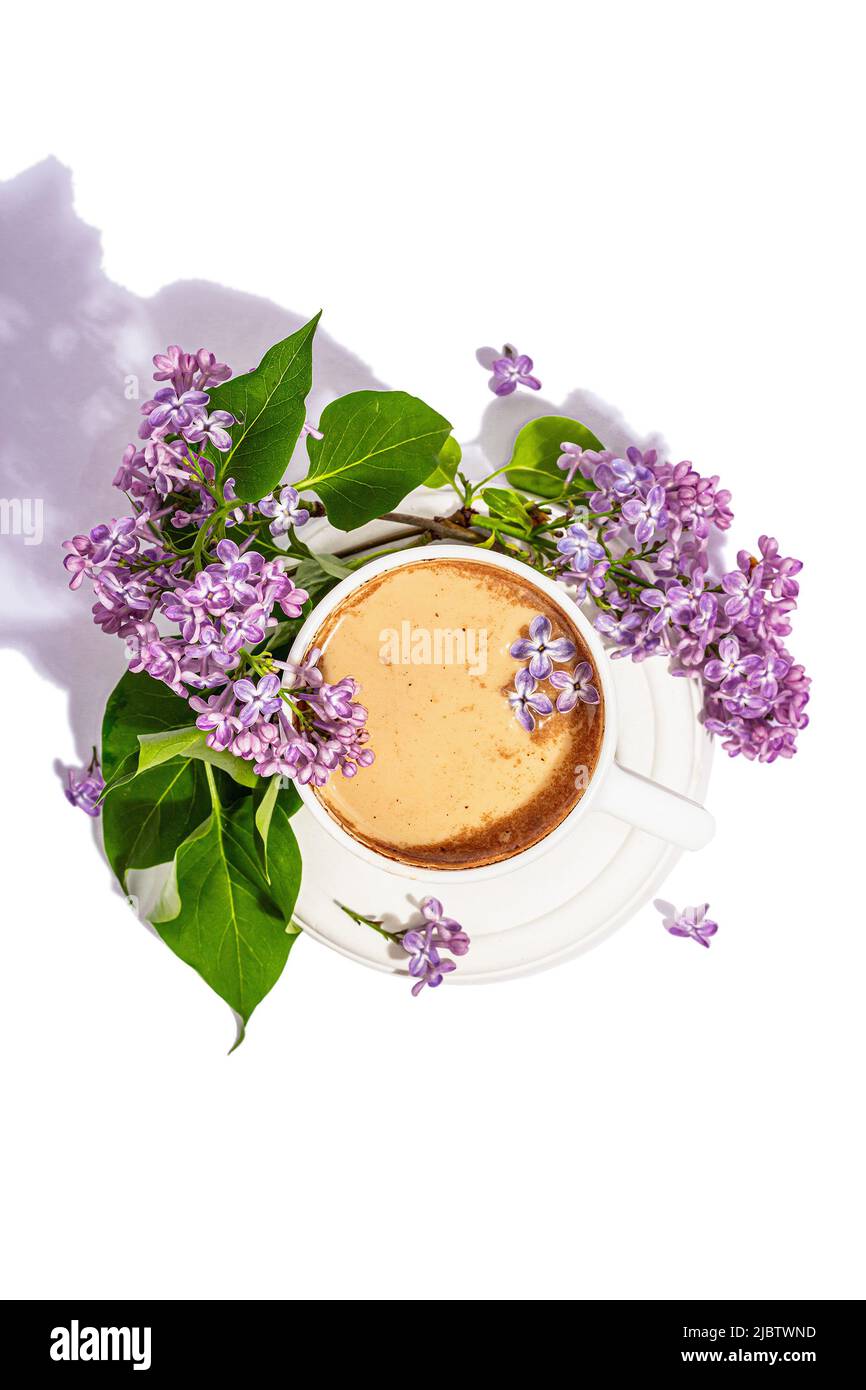Cup of coffee and lilac flowers bouquet isolated on a white background ...