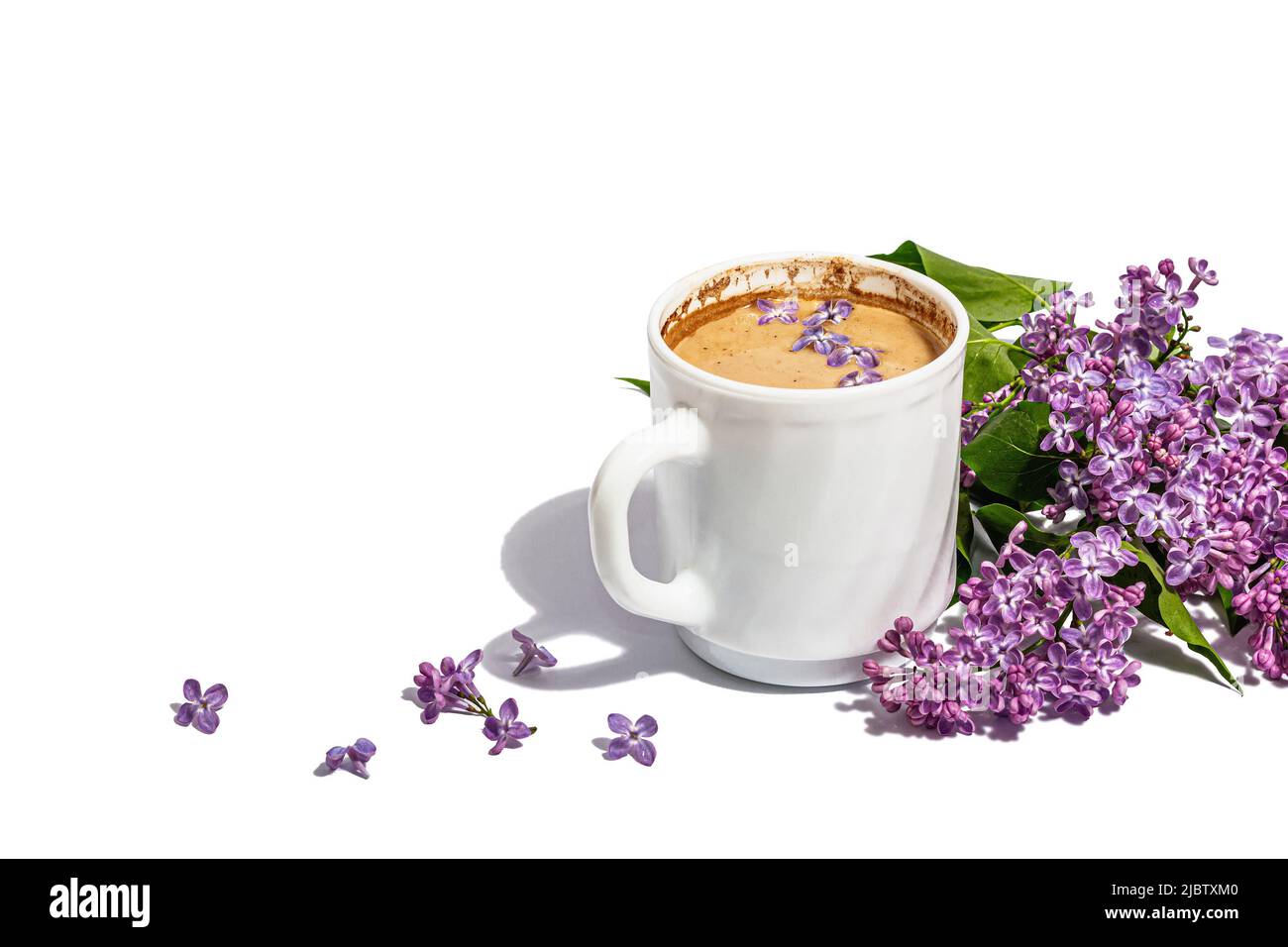Cup of coffee and lilac flowers bouquet isolated on a white background ...