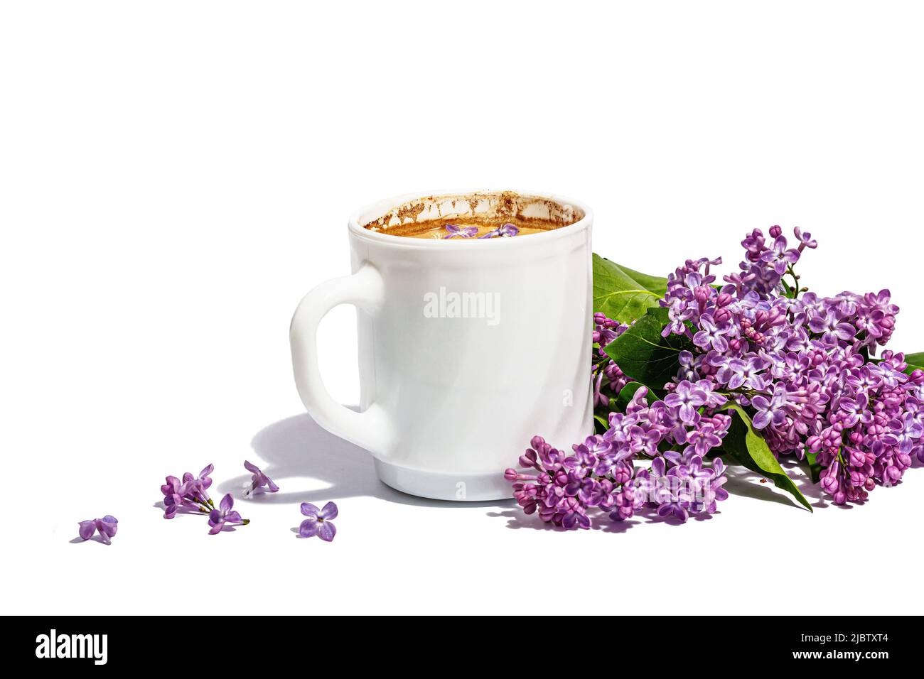 Cup of coffee and lilac flowers bouquet isolated on a white background ...