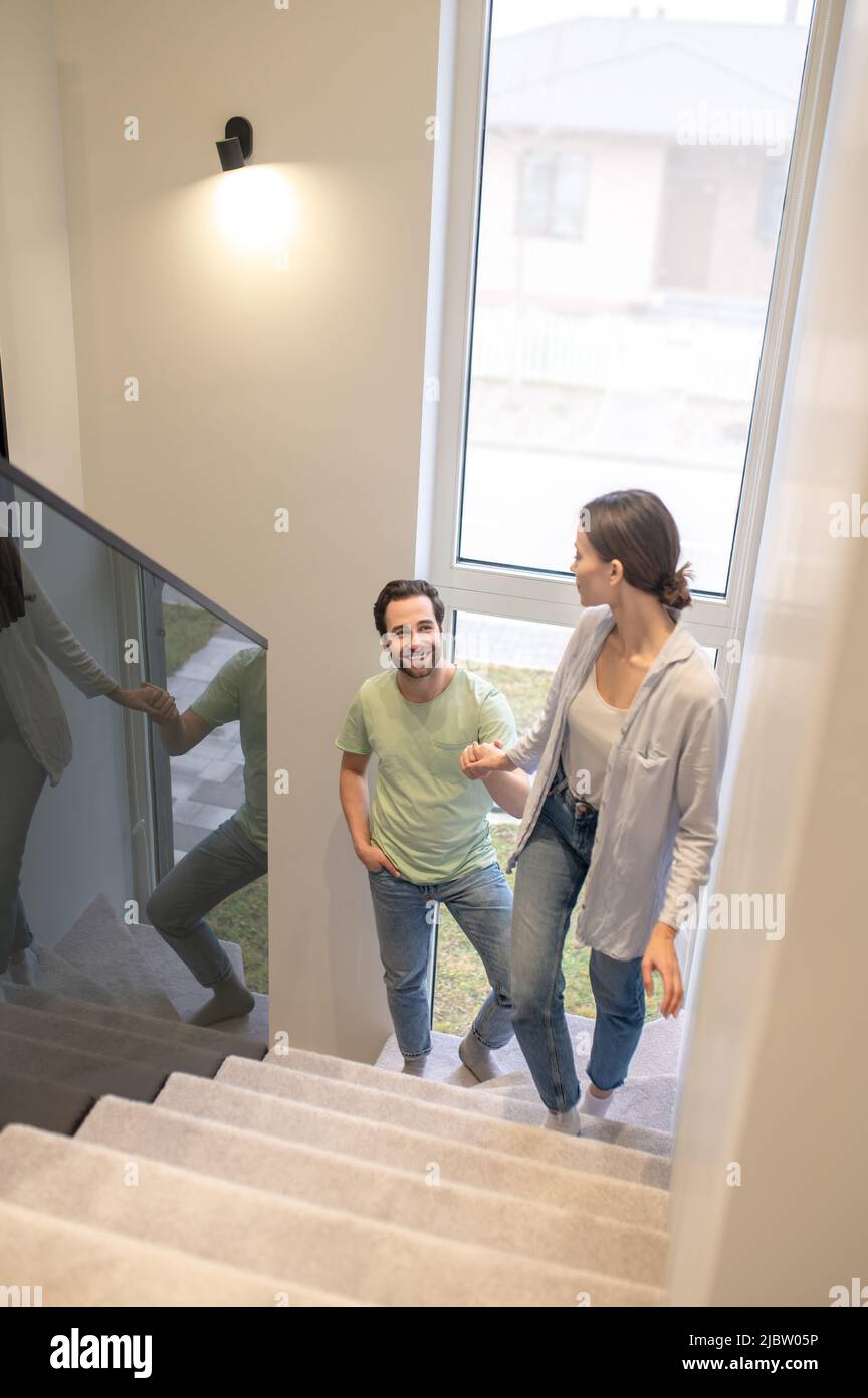 Woman climbing stairs home hi-res stock photography and images - Alamy