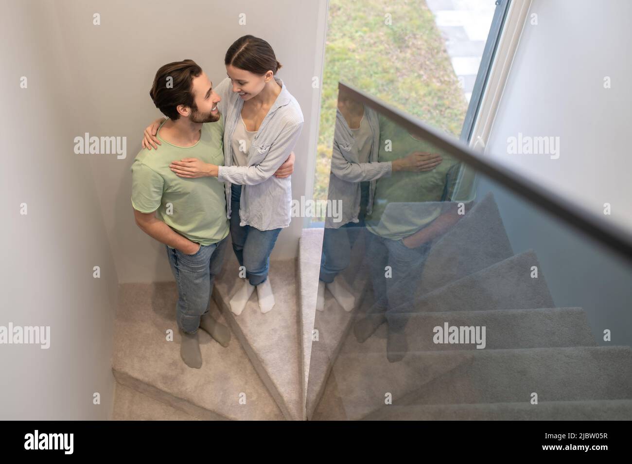 Top view of man and woman hugging on stairs Stock Photo - Alamy