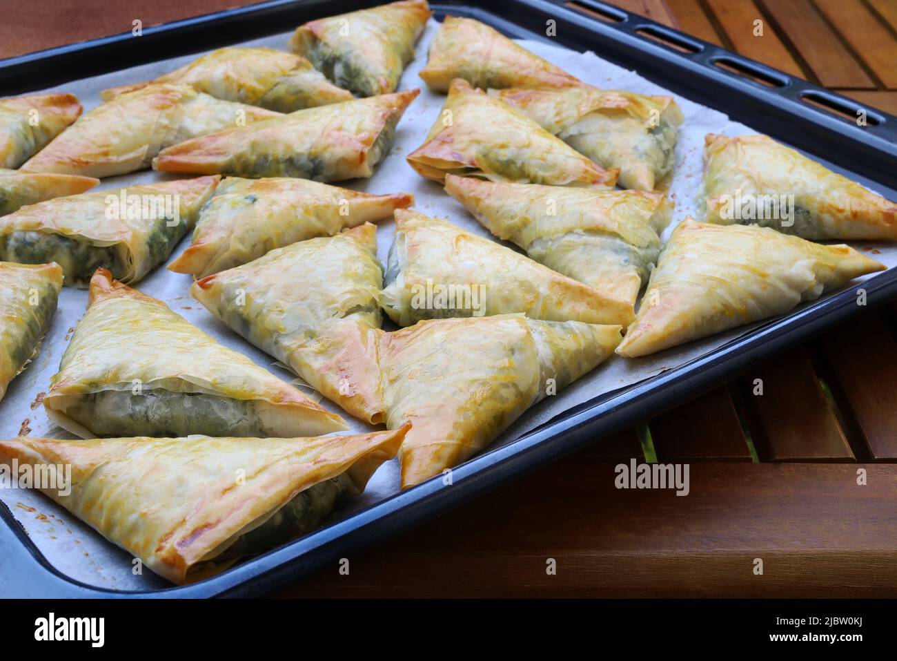 Greek food. Spanakopita, phyllo pastry triangle with spinach and feta ...