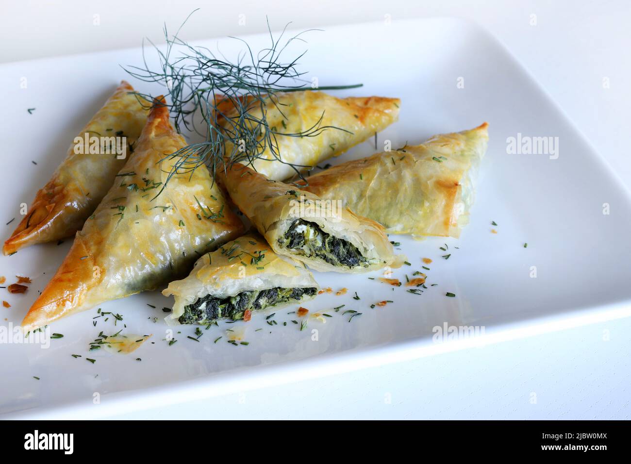 Greek food. Spanakopita, phyllo pastry triangle with spinach and feta ...