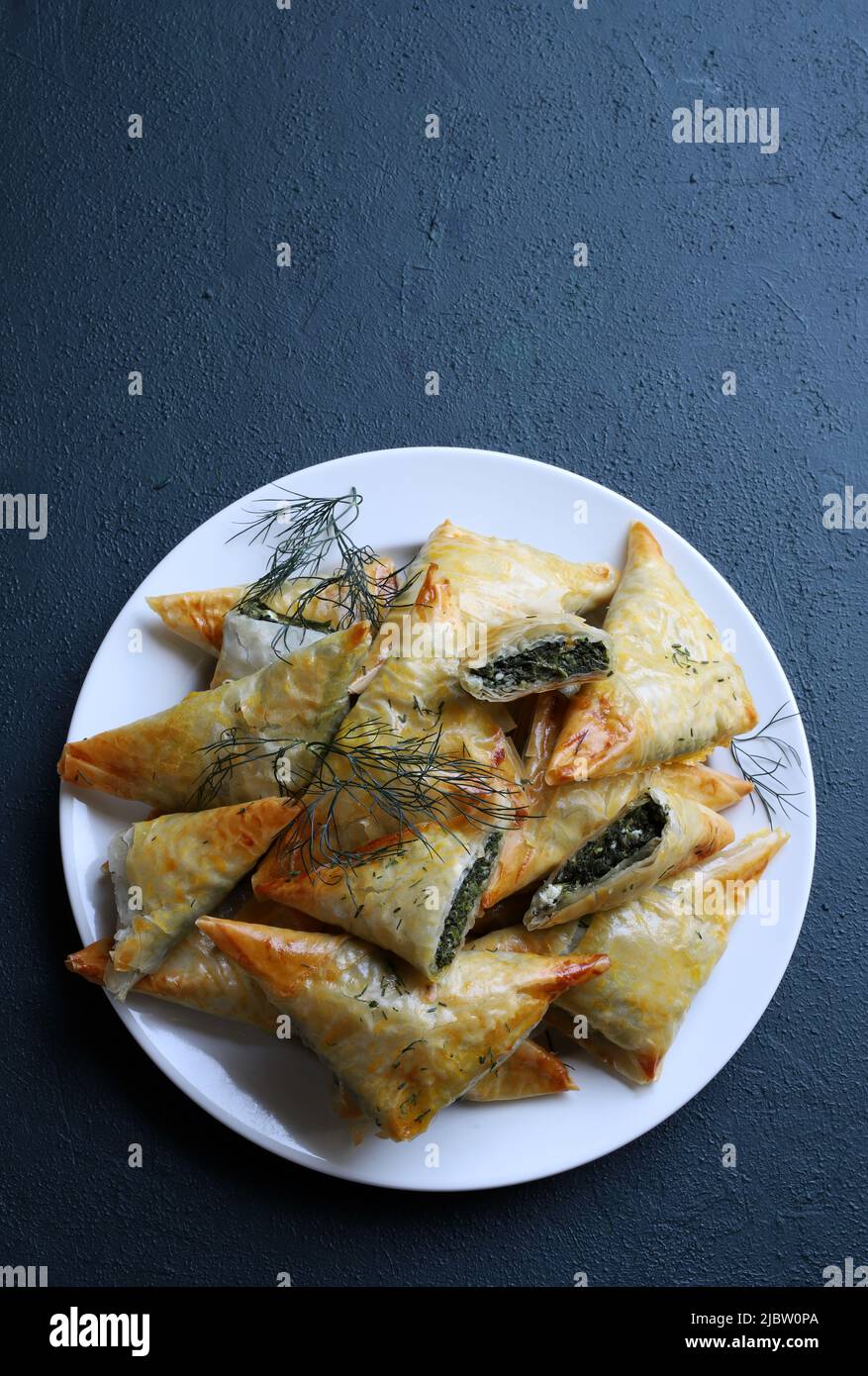 Traditional Greek cuisine. Spanakopita, crispy phyllo pastry triangles ...