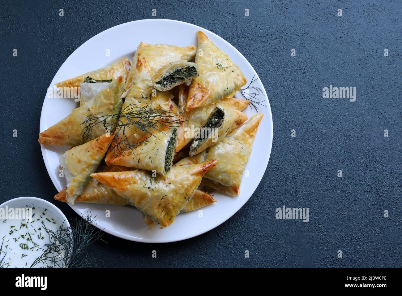 Traditional Greek cuisine. Spanakopita, crispy phyllo pastry triangles ...