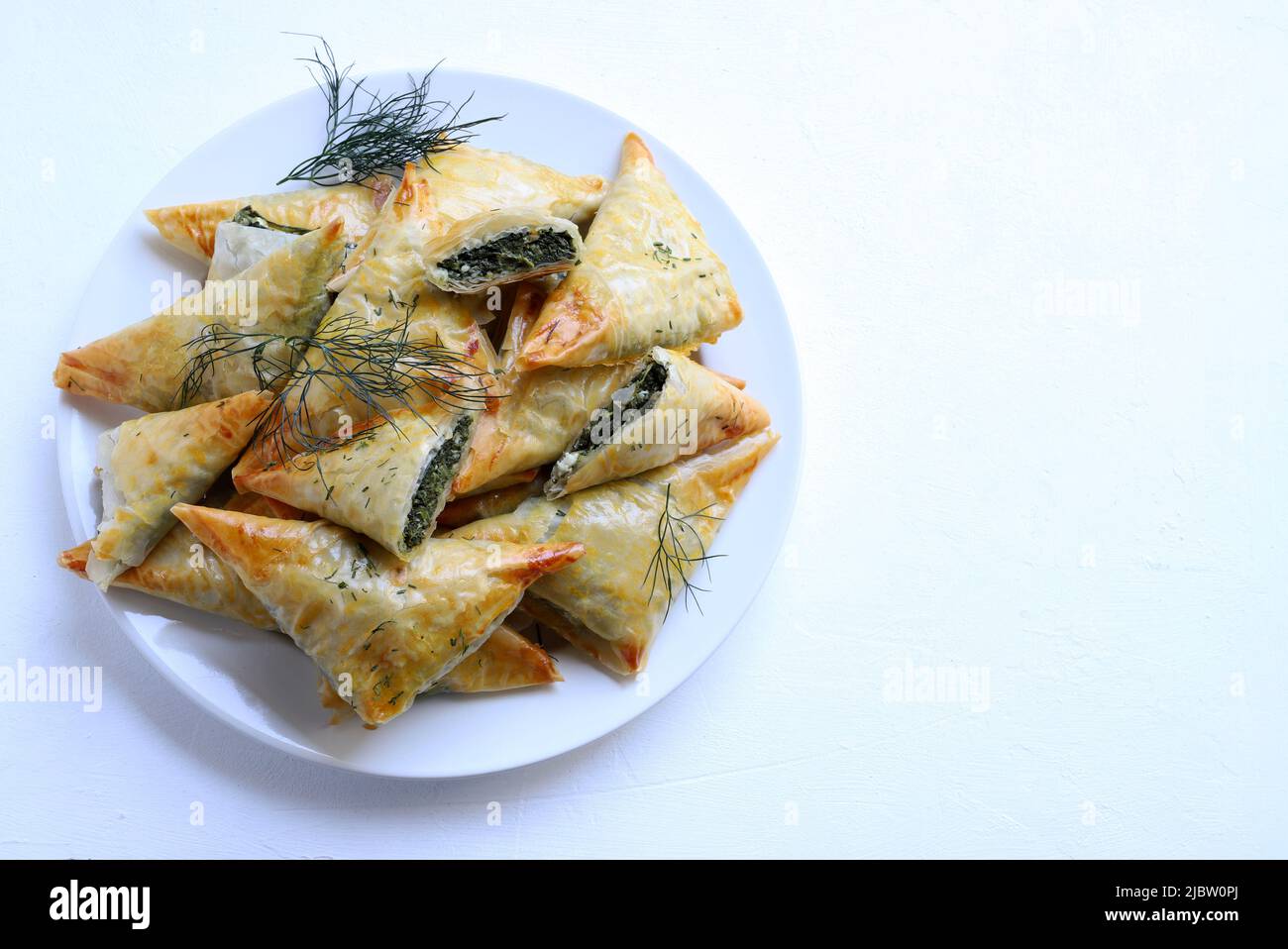 Greek food. Spanakopita, phyllo pastry triangle with spinach and feta ...