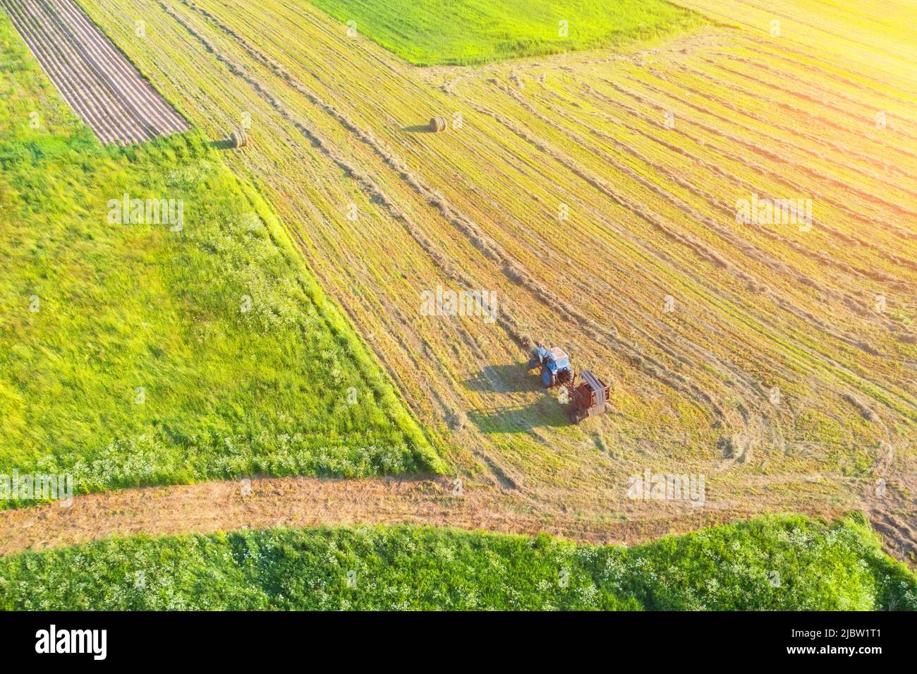 Farmer stores fodder for cattle in summer season. Aerial view on a ...