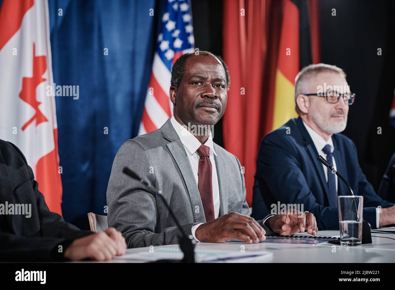 Sitting meeting conference table authority politician hi-res stock ...