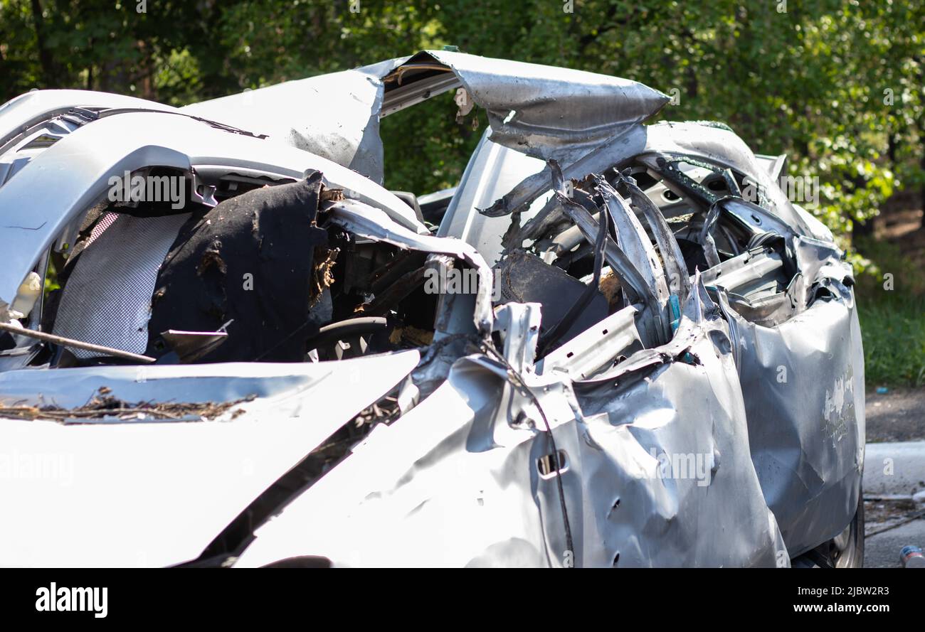 The remains of a civilian car, which was shot and destroyed by shell ...