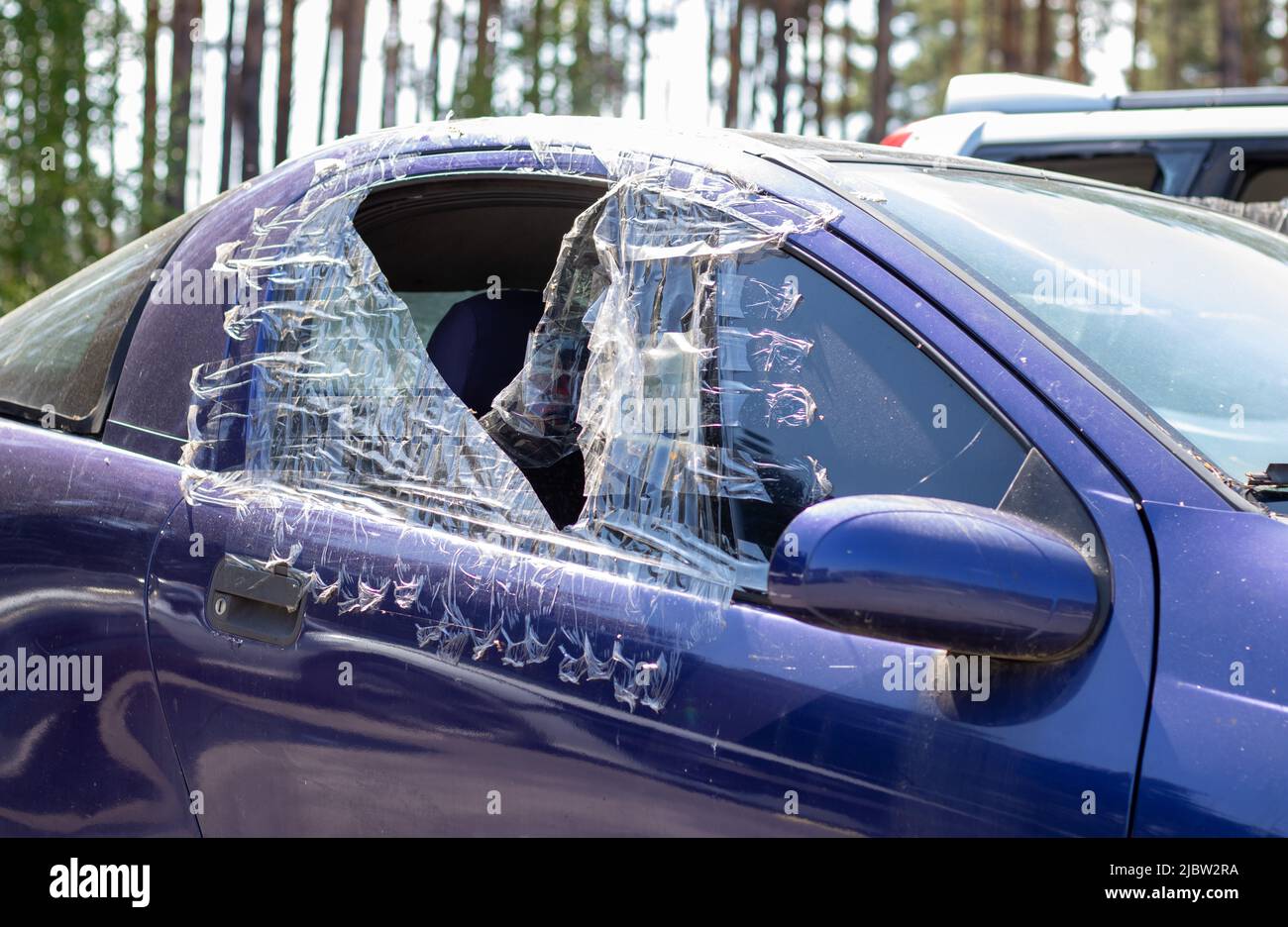 Criminal incident. Breaking into a car parked on the street. Broken ...