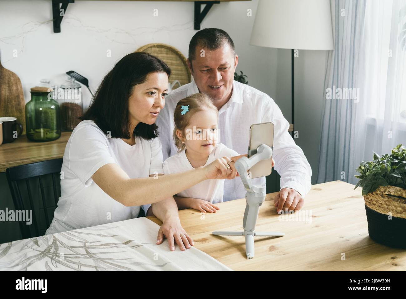 A little girl with her mother poke a finger at the phone screen Stock ...