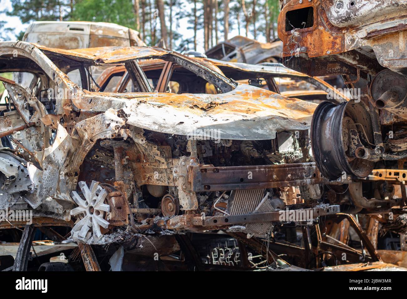 Cars after the fire. Iron parts of a burnt car. Burnt-out cars ...