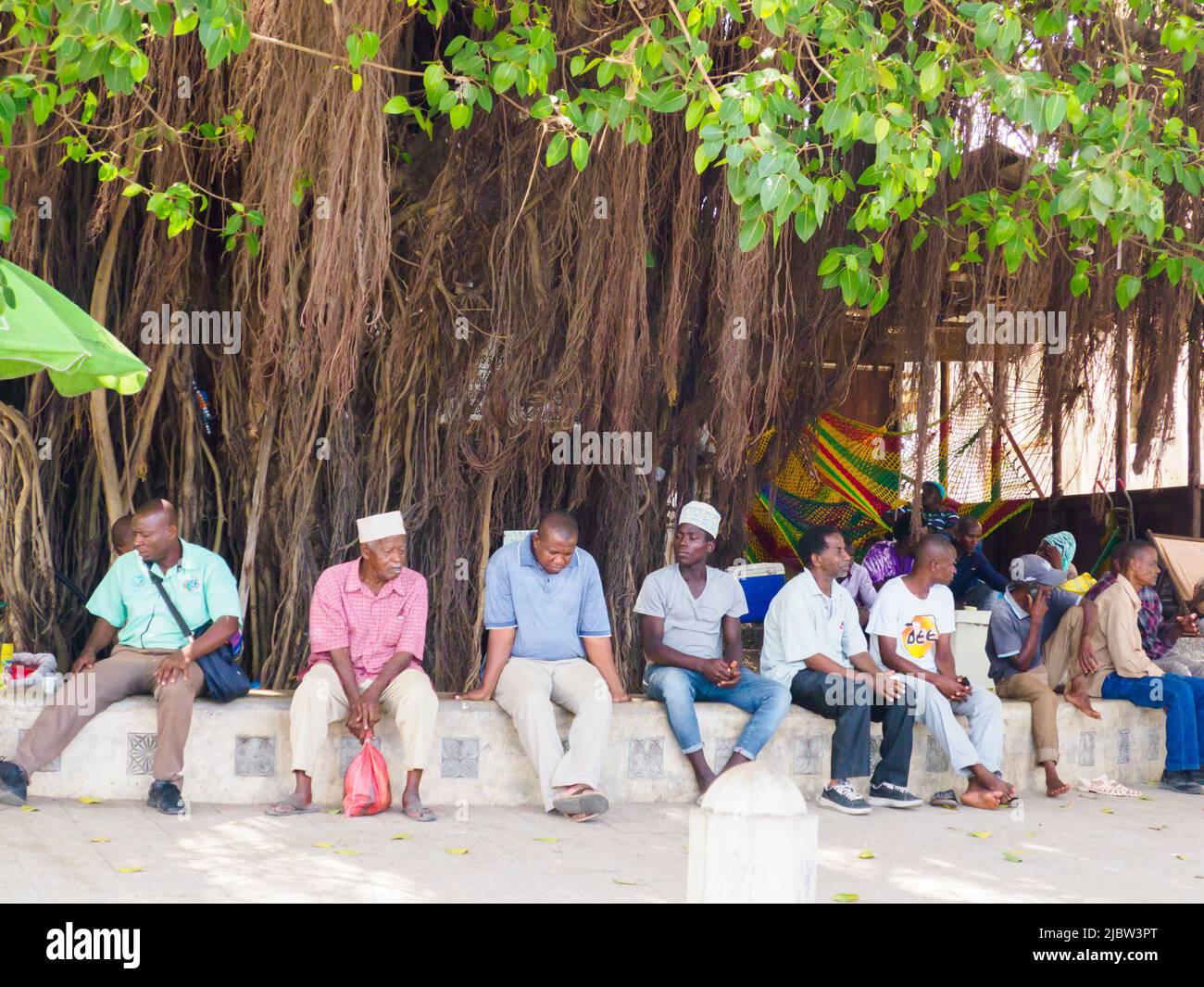 Stone, Town, Zanzibar - Feb 2021: A group of African men rest under a ...