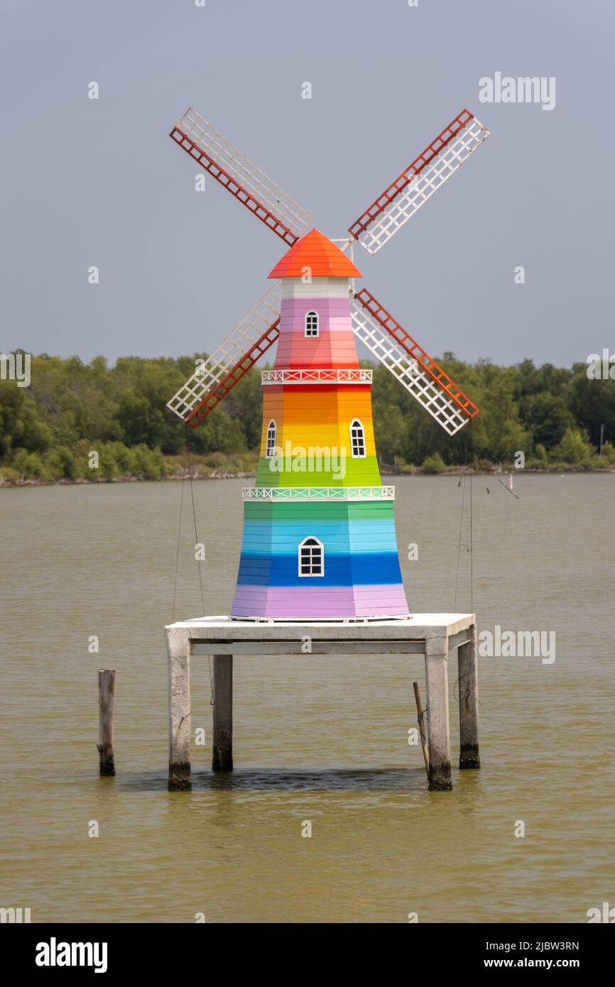 Decorative model of a windmill standing by a wooden structure over ...
