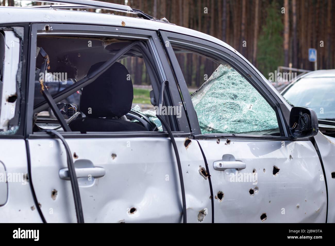 Car riddled with bullets. War of Russia against Ukraine. A car of ...