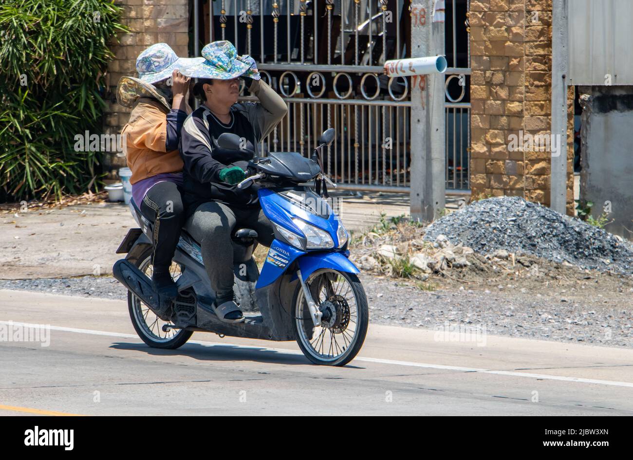 BANGKOK, THAILAND, APR 25 2022, Two women ride a motorcycle with hats ...