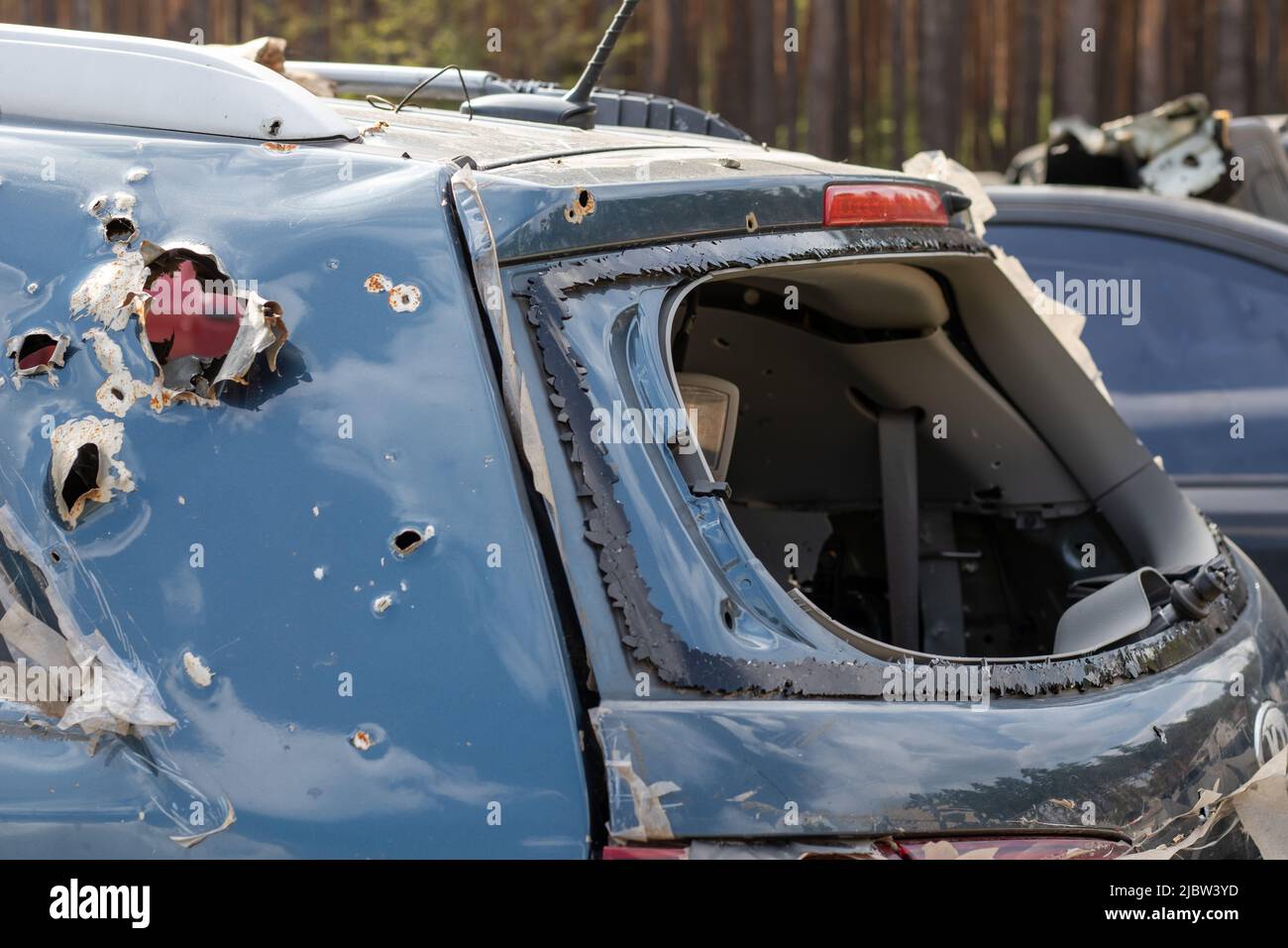 Car riddled with bullets. War of Russia against Ukraine. A car of ...