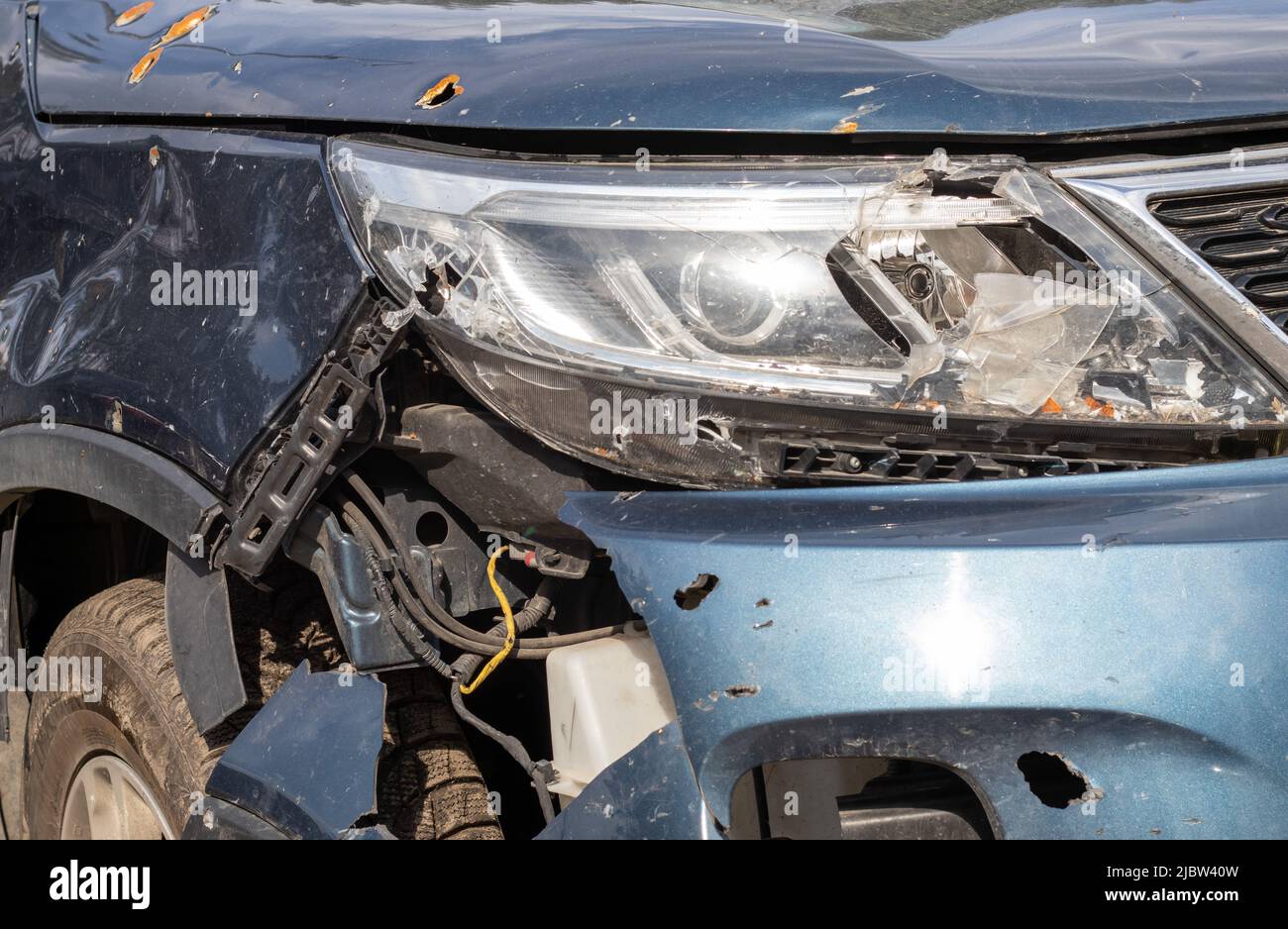 Broken headlights as a result of a collision. Broken blue car after an ...