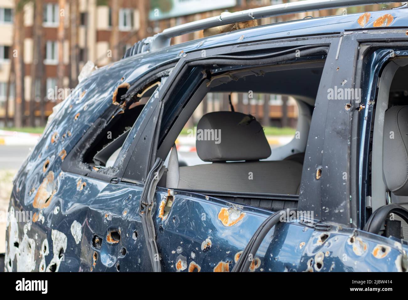 Car riddled with bullets. War of Russia against Ukraine. A car of ...