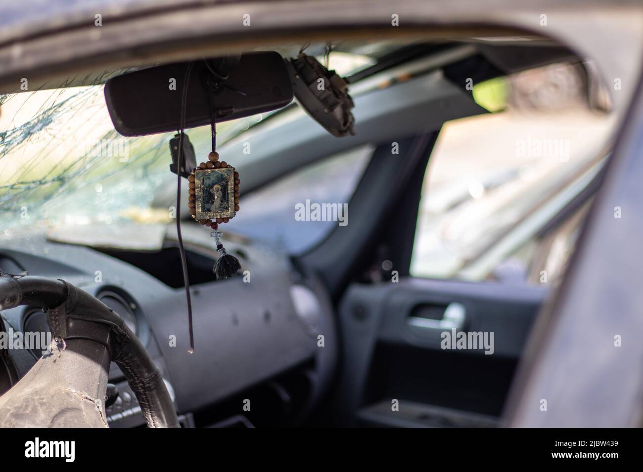 The driver's airbag deployed on the steering wheel of the car after the ...