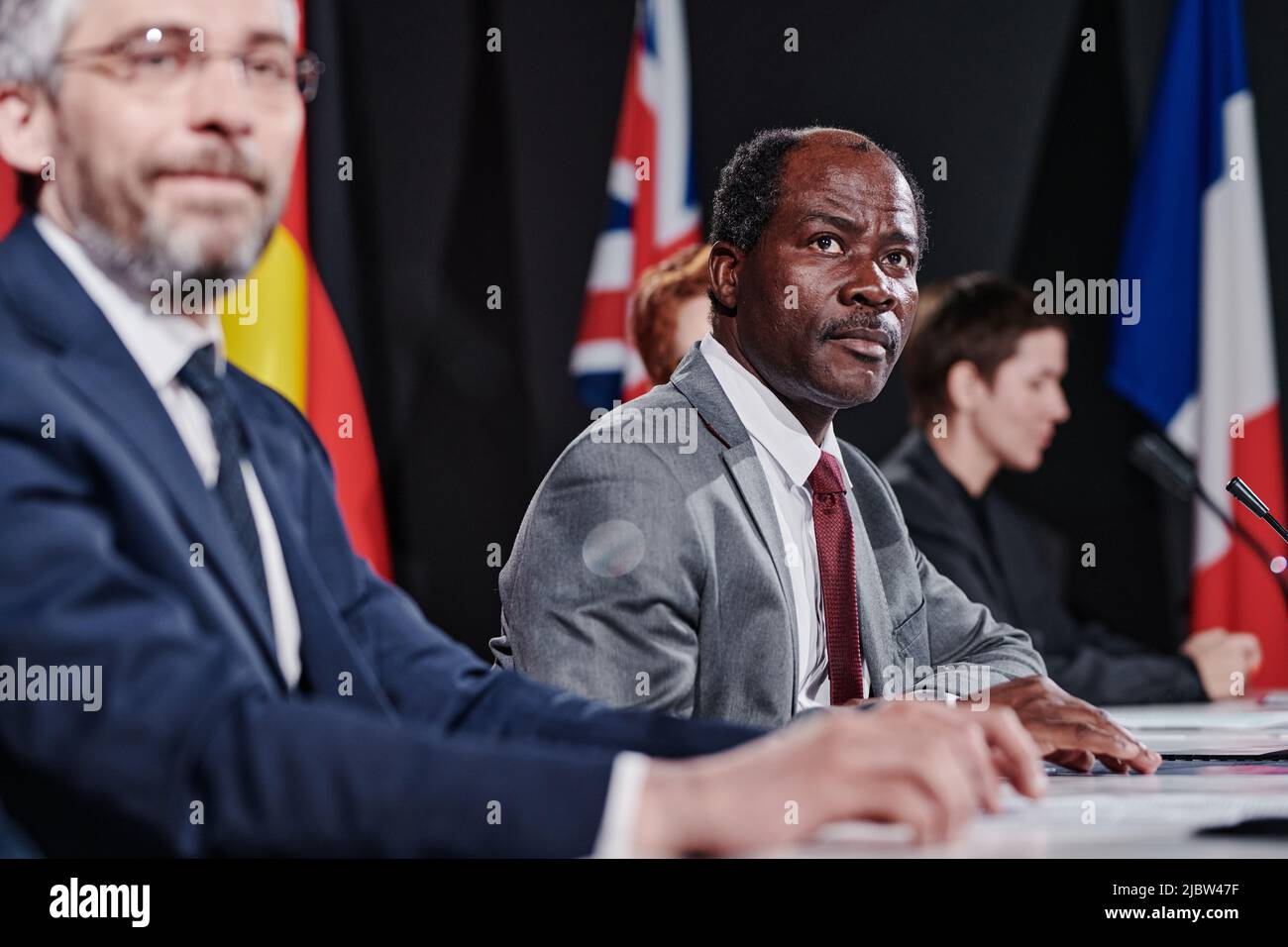 African american mature politician in suit sitting at meeting together ...