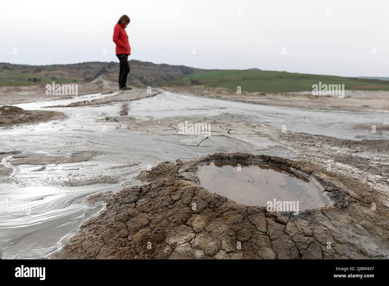 Woman standing at Takhti-Tepha Mud Volcanoes in Chachuna Managed Nature ...