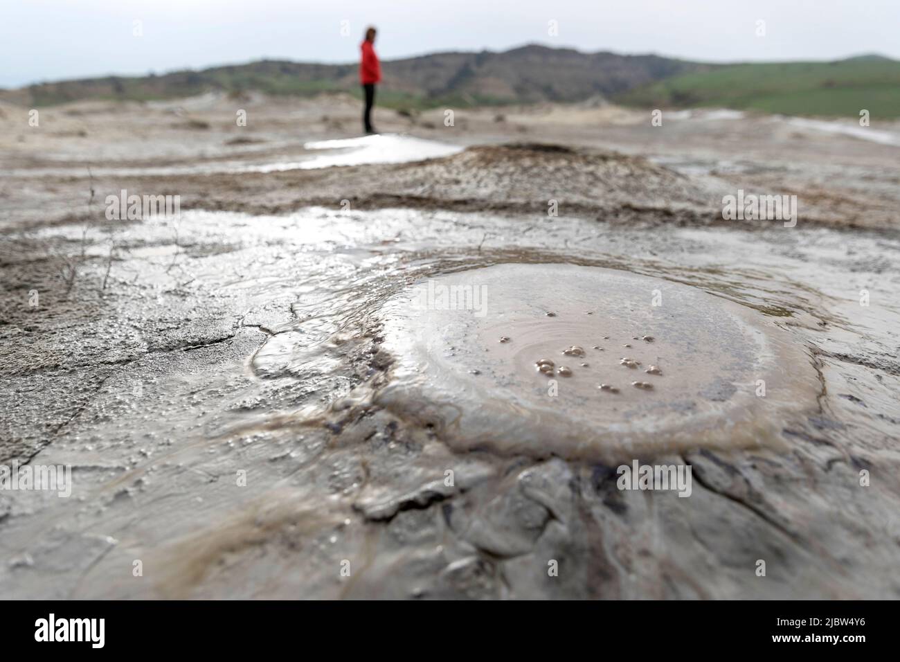 Woman standing at Takhti-Tepha Mud Volcanoes in Chachuna Managed Nature ...