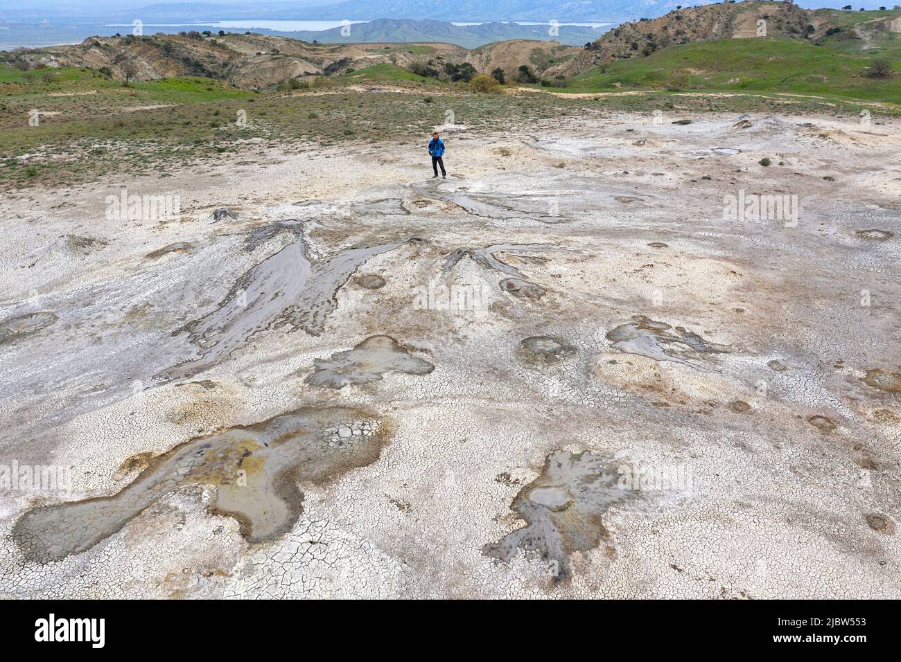 Aerial view of man standing at Takhti-Tepha Mud Volcanoes in Chachuna ...