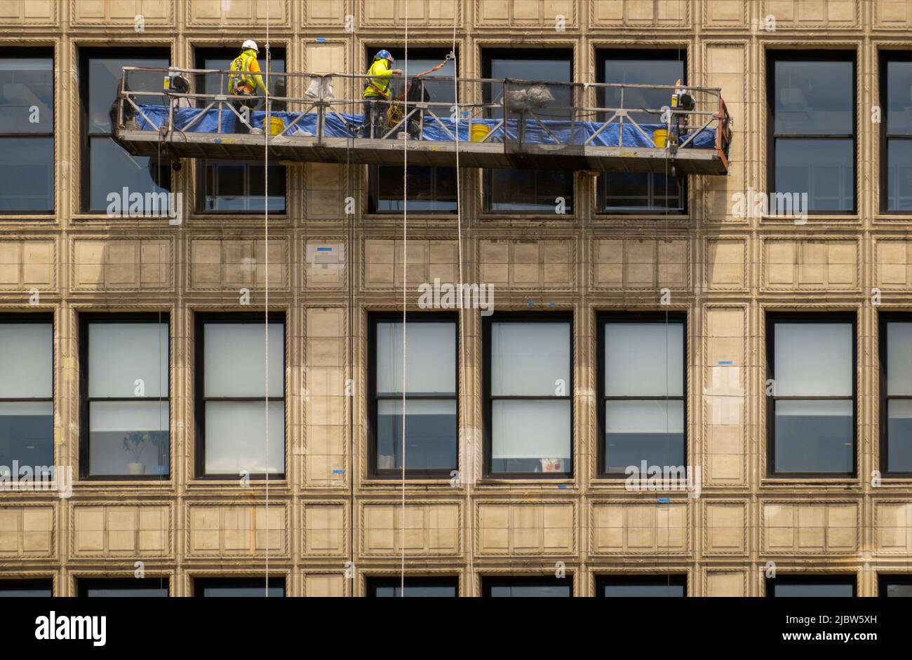 washing windows on a large building in Union Square district of ...