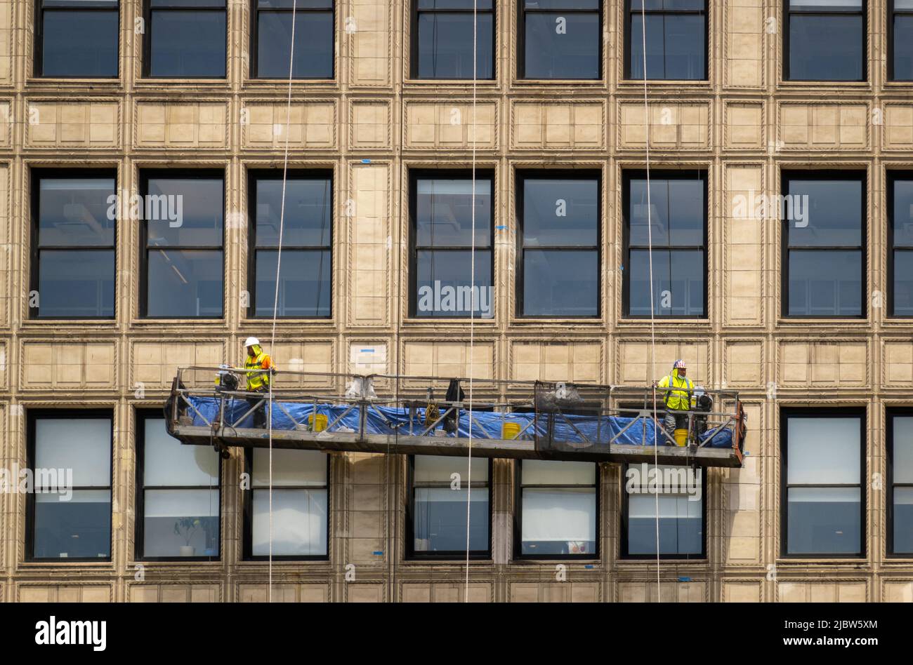 washing windows on a large building in Union Square district of ...