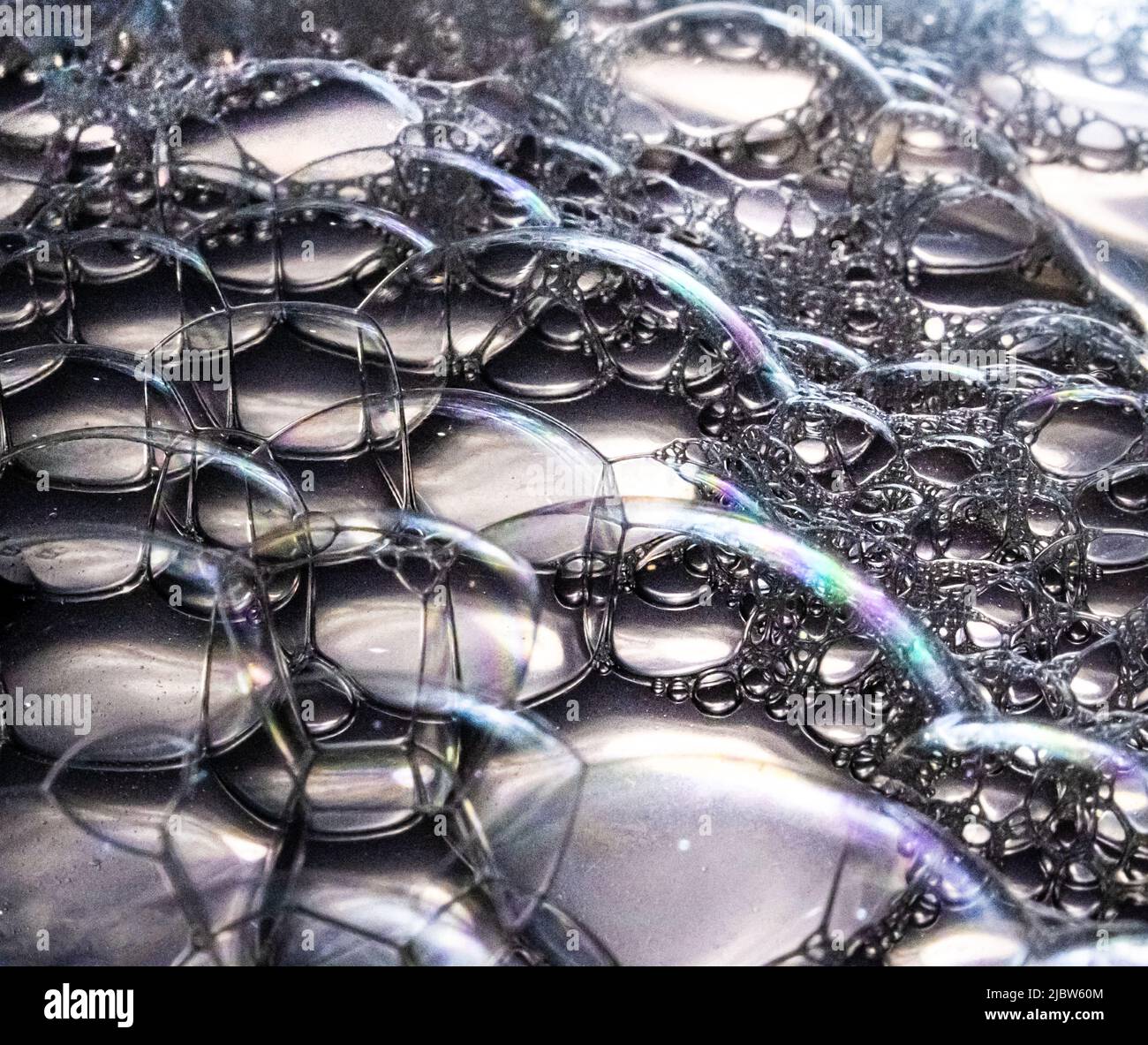 Bubbles made from water, dish liquid, oil, and food coloring creating a ...