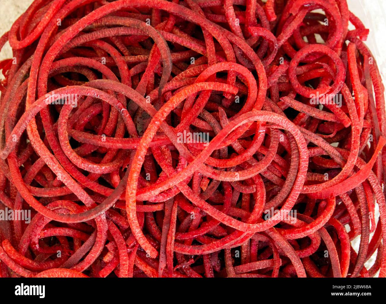 raw red beets cut up with a spiral slicer ready to eat Stock Photo - Alamy