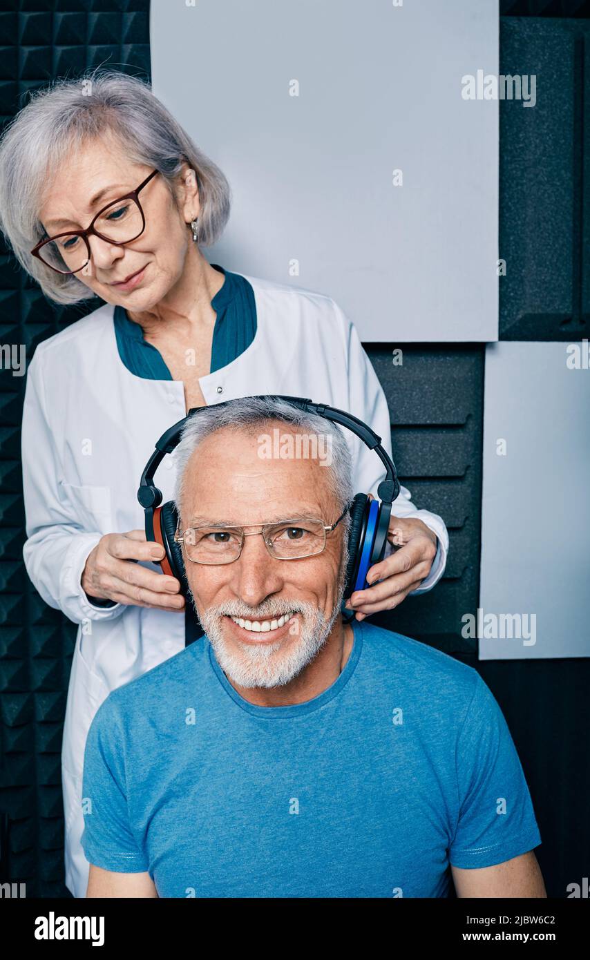 Audiometry, pure tone audiogram test. Audiologist doing hearing exam to ...