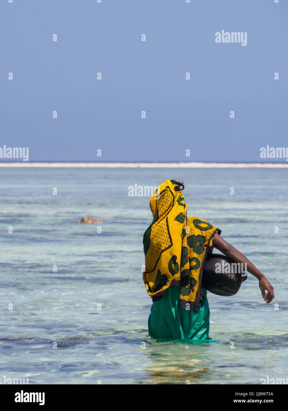 Matemwe, Zanzibar - January 2021: Woman in green dress and yellow ...